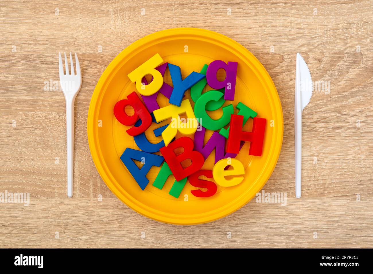 Fork, knife and plate with colored letters Stock Photo - Alamy
