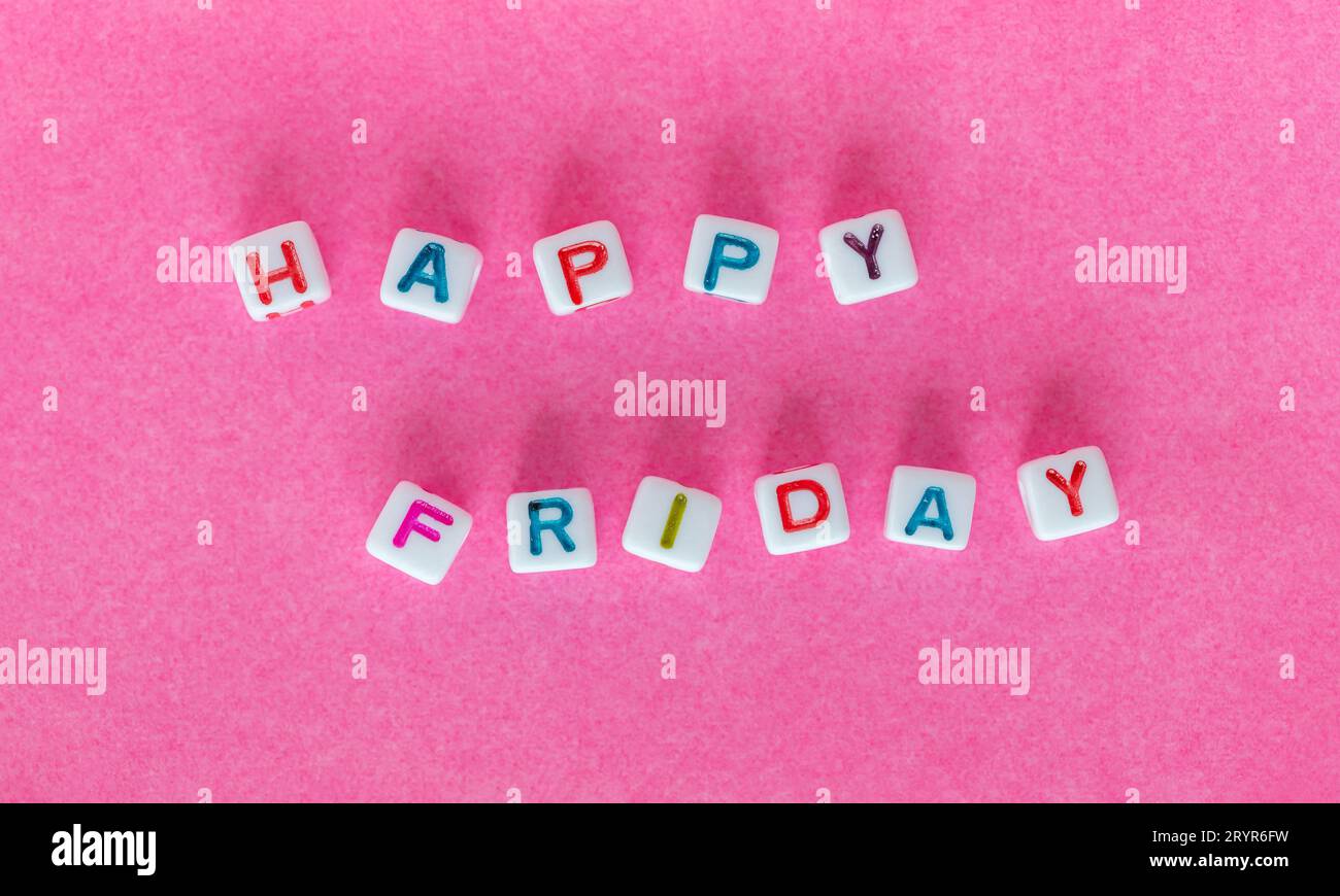 Phrase Happy Friday made out of square beads on bright pink background ...