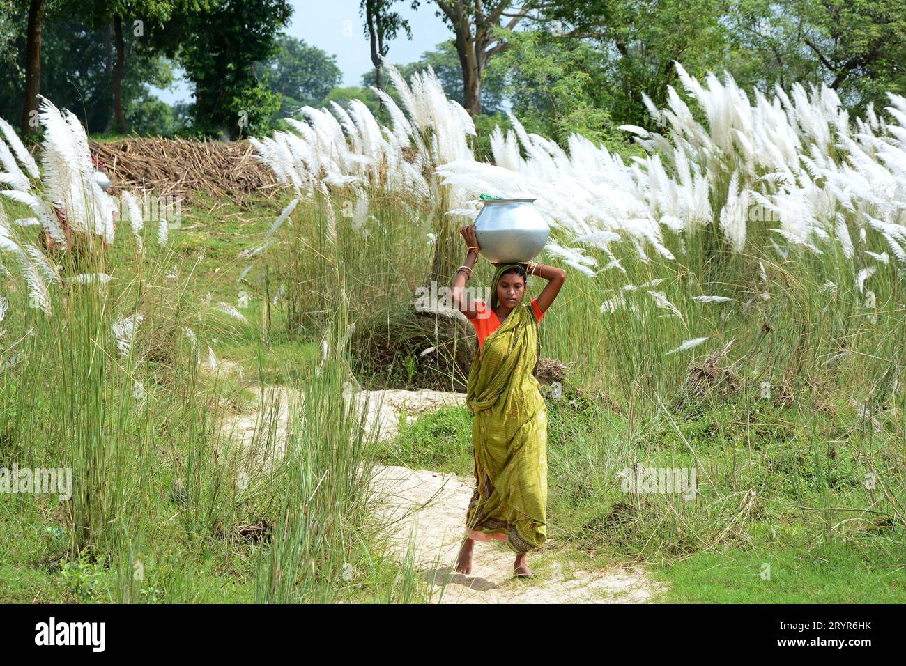 The mother carrying drinking water from far away with their children of ...