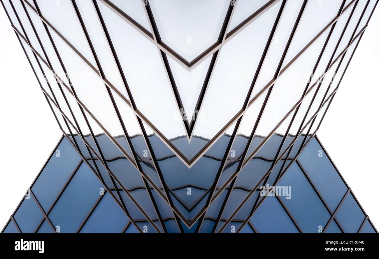 Distorted reflections in the mirrored windows of a modern building ...