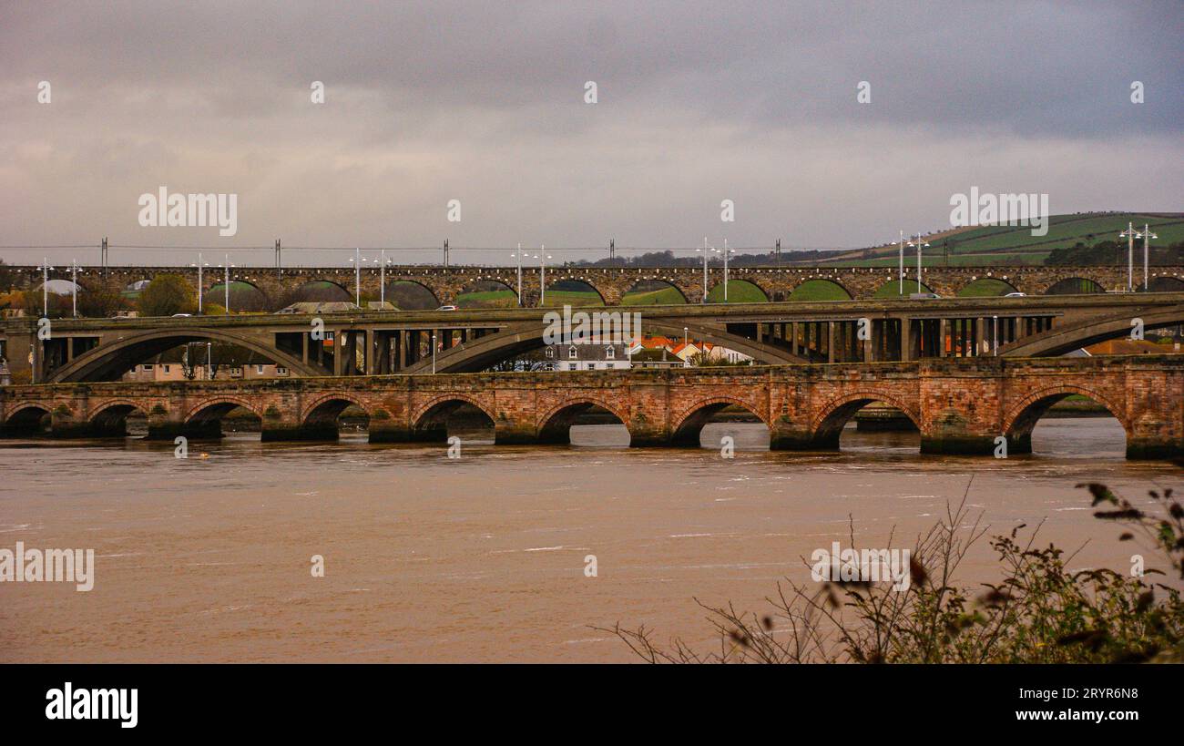 A bridge spanning a river in a bustling city: the river Tweed in ...