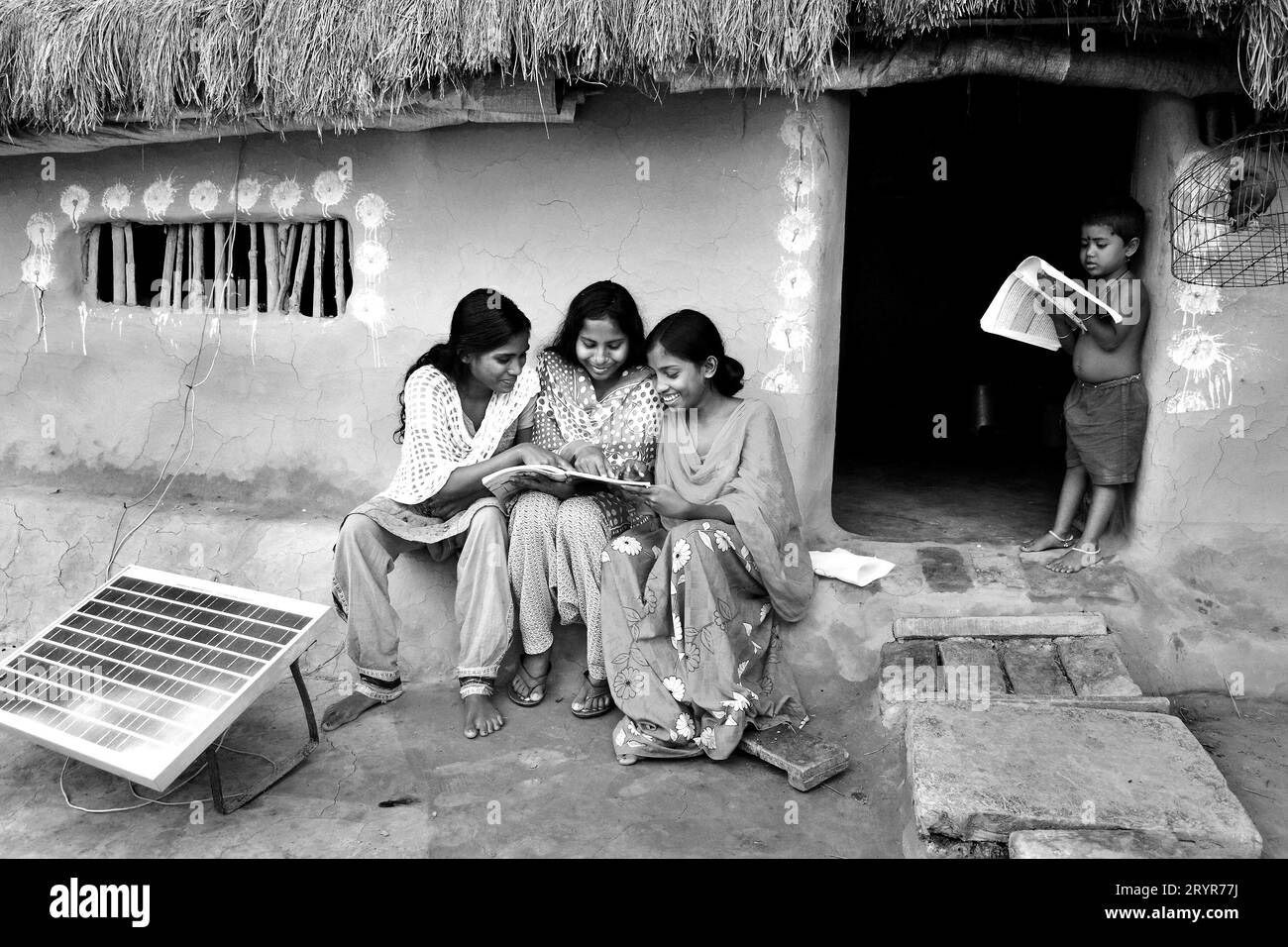 The remote village children are learning their books in front of their ...