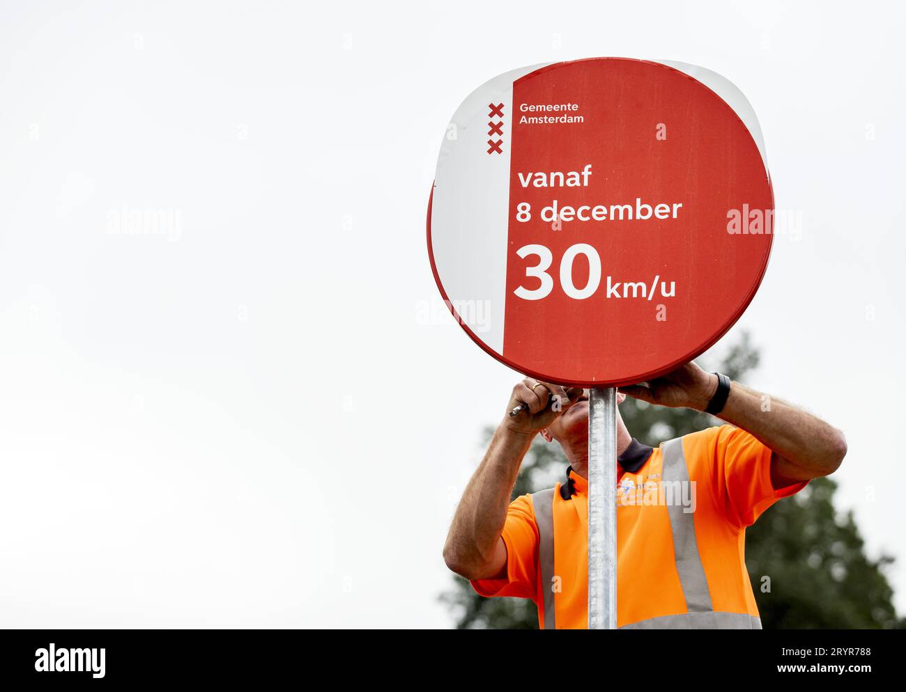 AMSTERDAM - A municipal employee places a speed sign. Amsterdam is ...