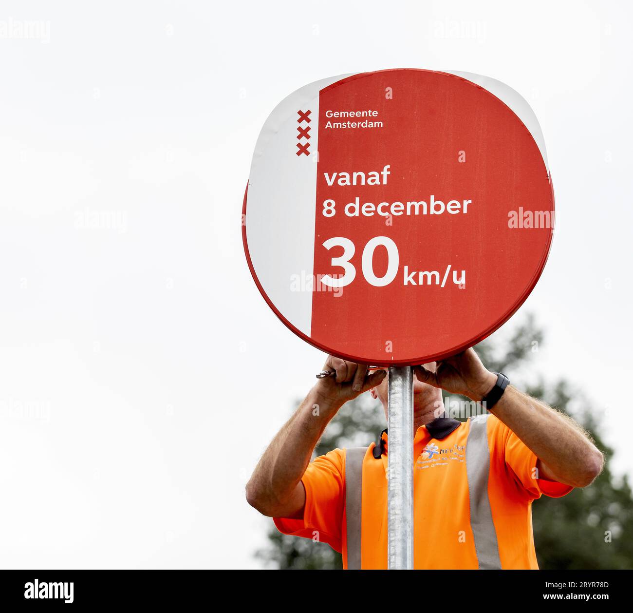 AMSTERDAM - A municipal employee places a speed sign. Amsterdam is ...