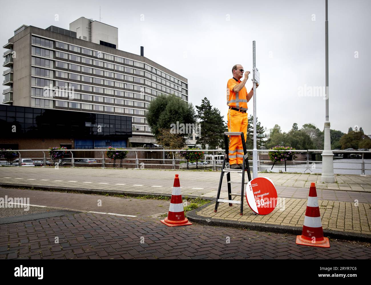AMSTERDAM - A municipal employee places a speed sign. Amsterdam is ...