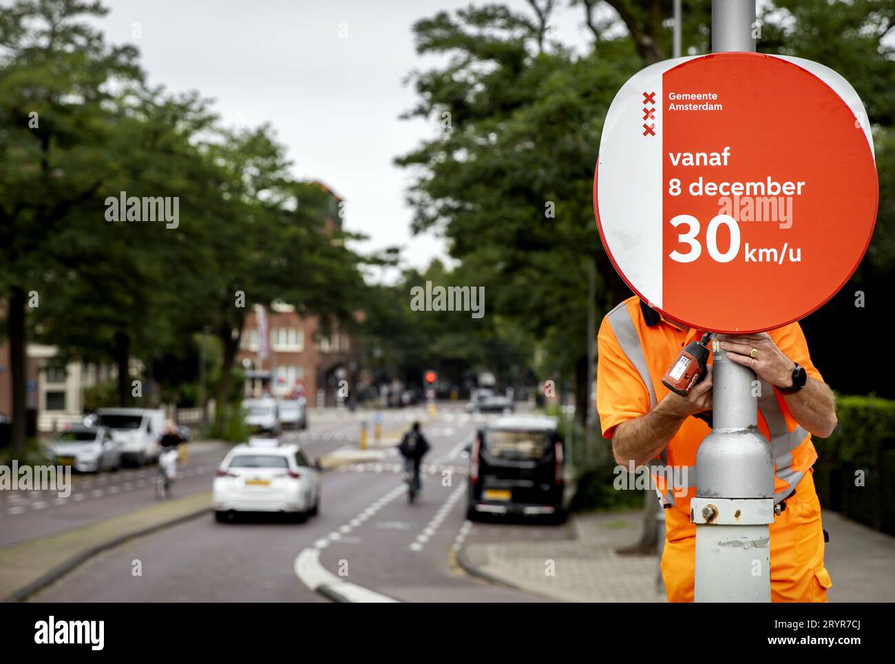 AMSTERDAM - A municipal employee places a speed sign. Amsterdam is ...