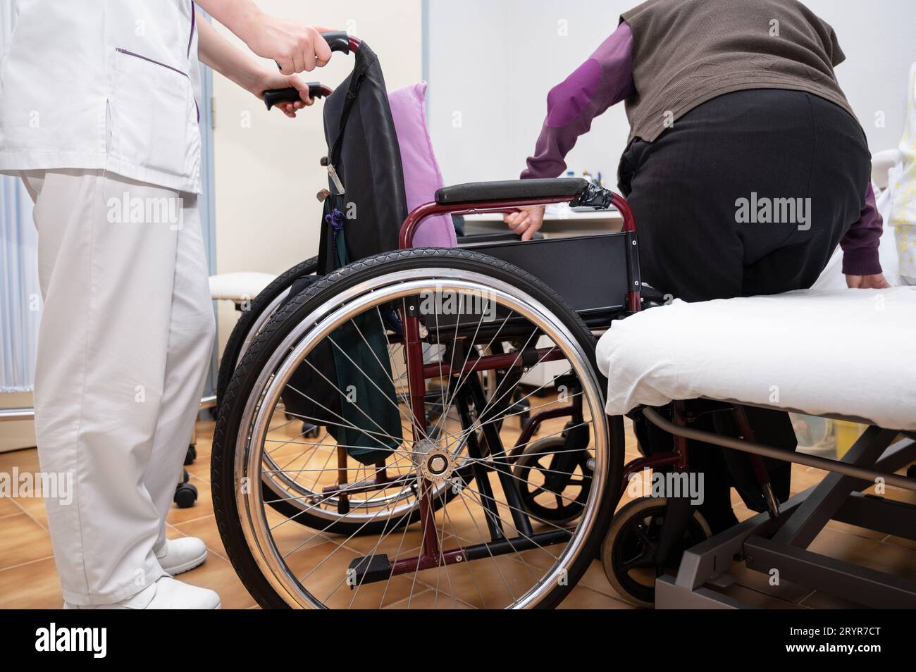 Young woman doctor give support to old lady patient with disability ...