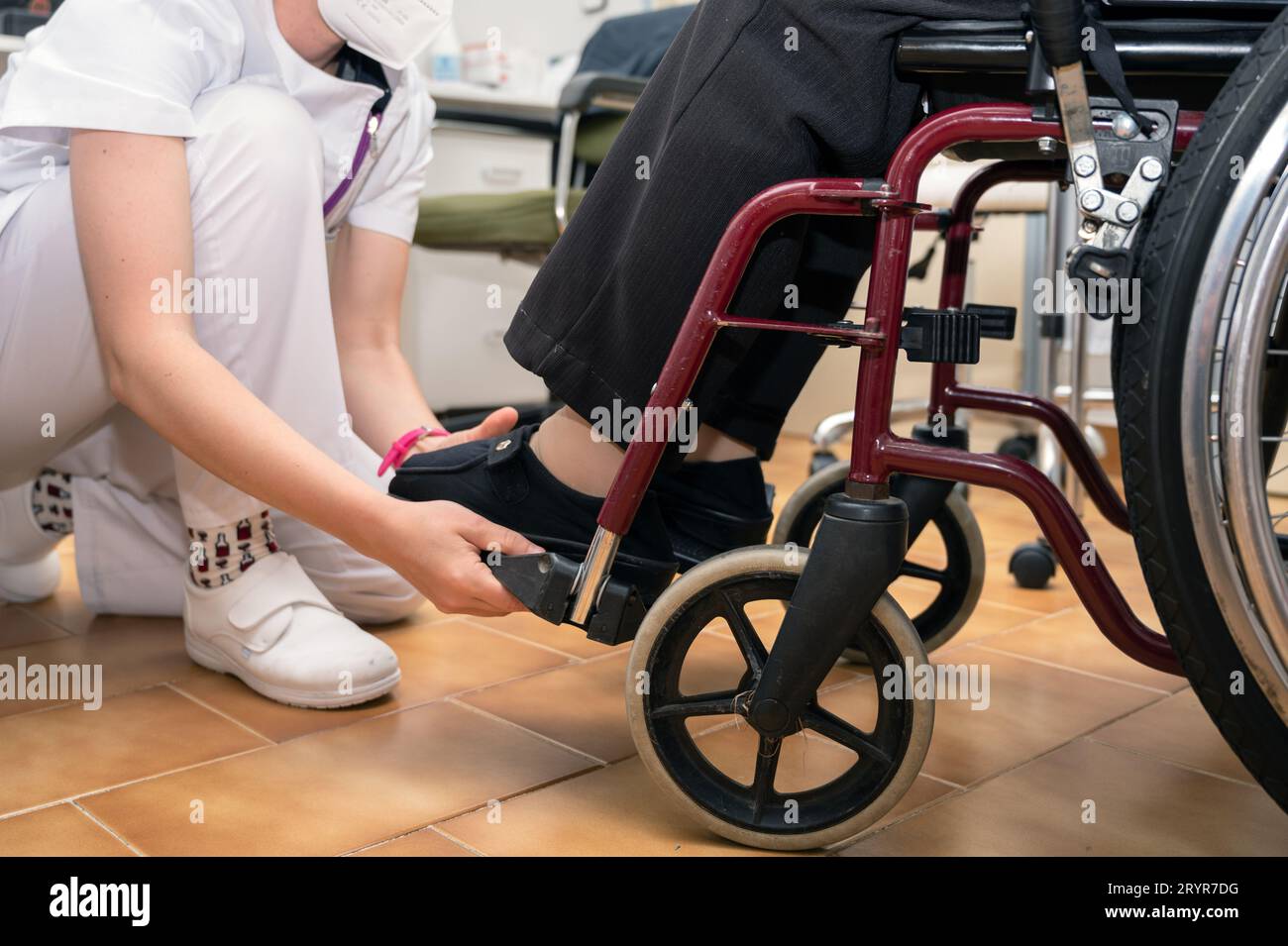 Young woman doctor give support to old lady patient with disability ...