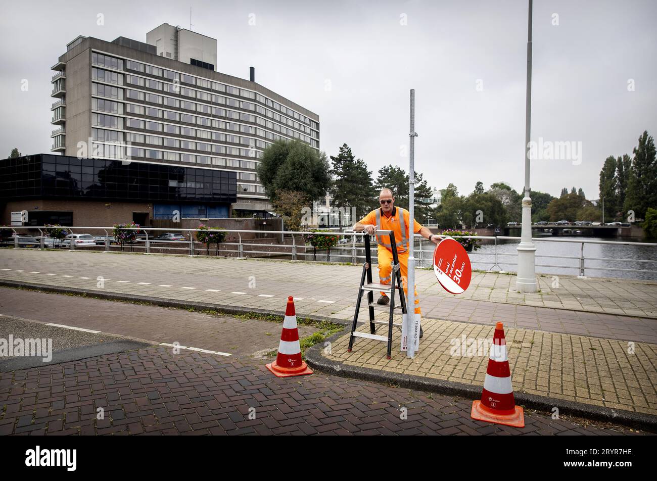 AMSTERDAM - A municipal employee places a speed sign. Amsterdam is ...