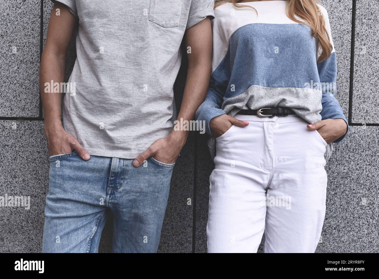 Photo A young modern couple of teenagers in the background of the Wall ...