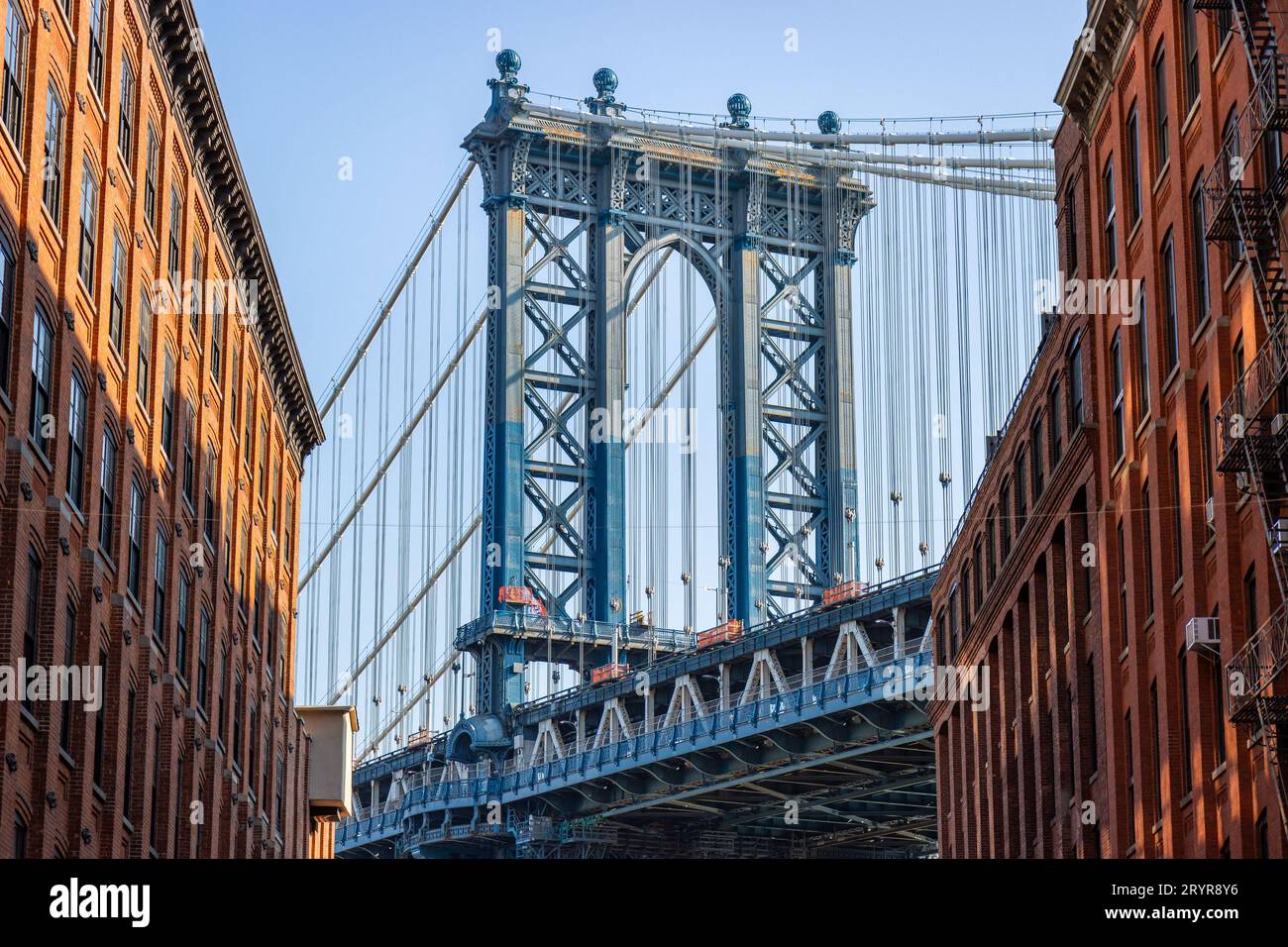 The Manhattan Bridge between buildings in the Dumbo neighborhood in ...