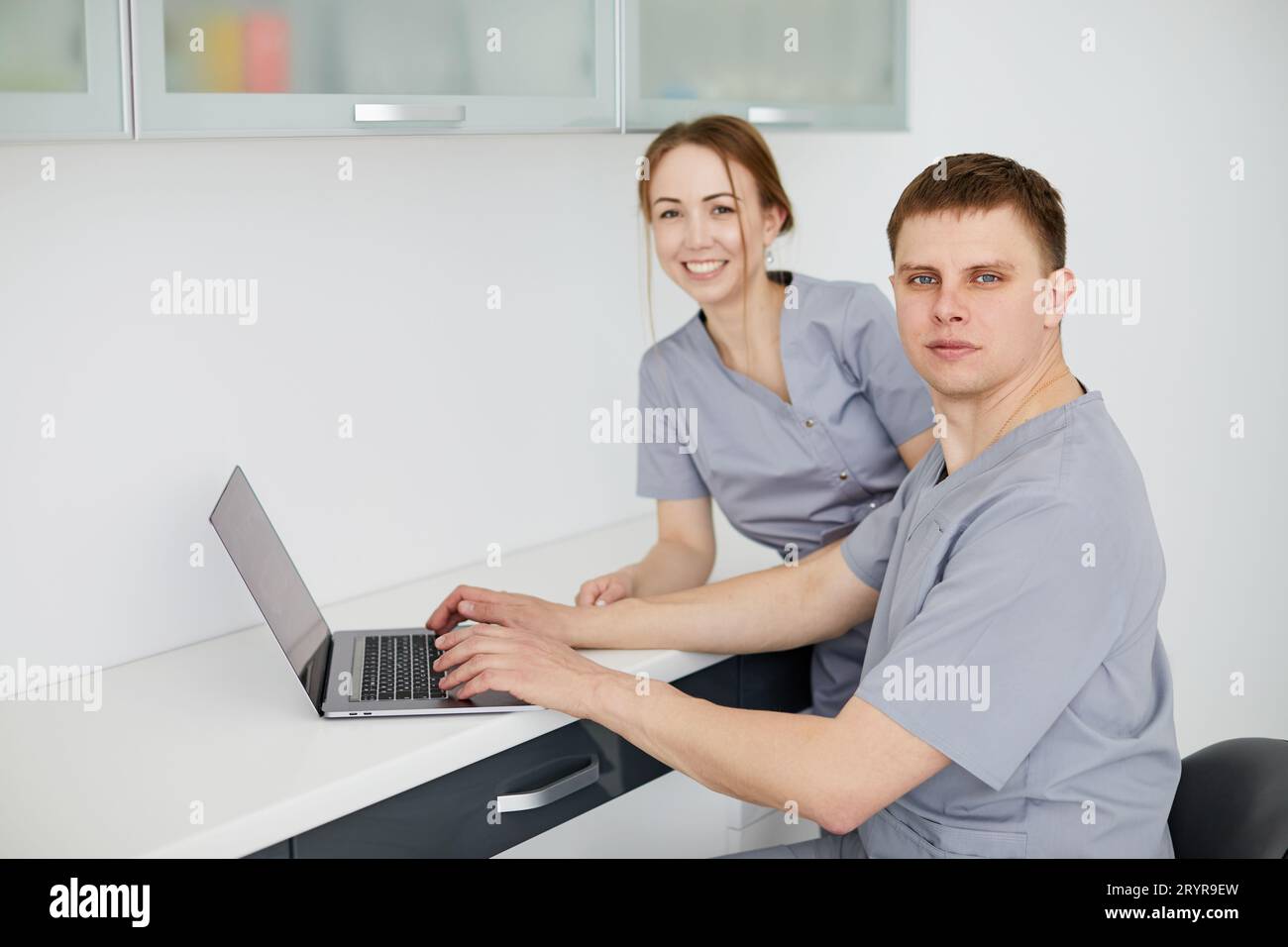Group of cheerful healthcare workers working together at doctor's ...
