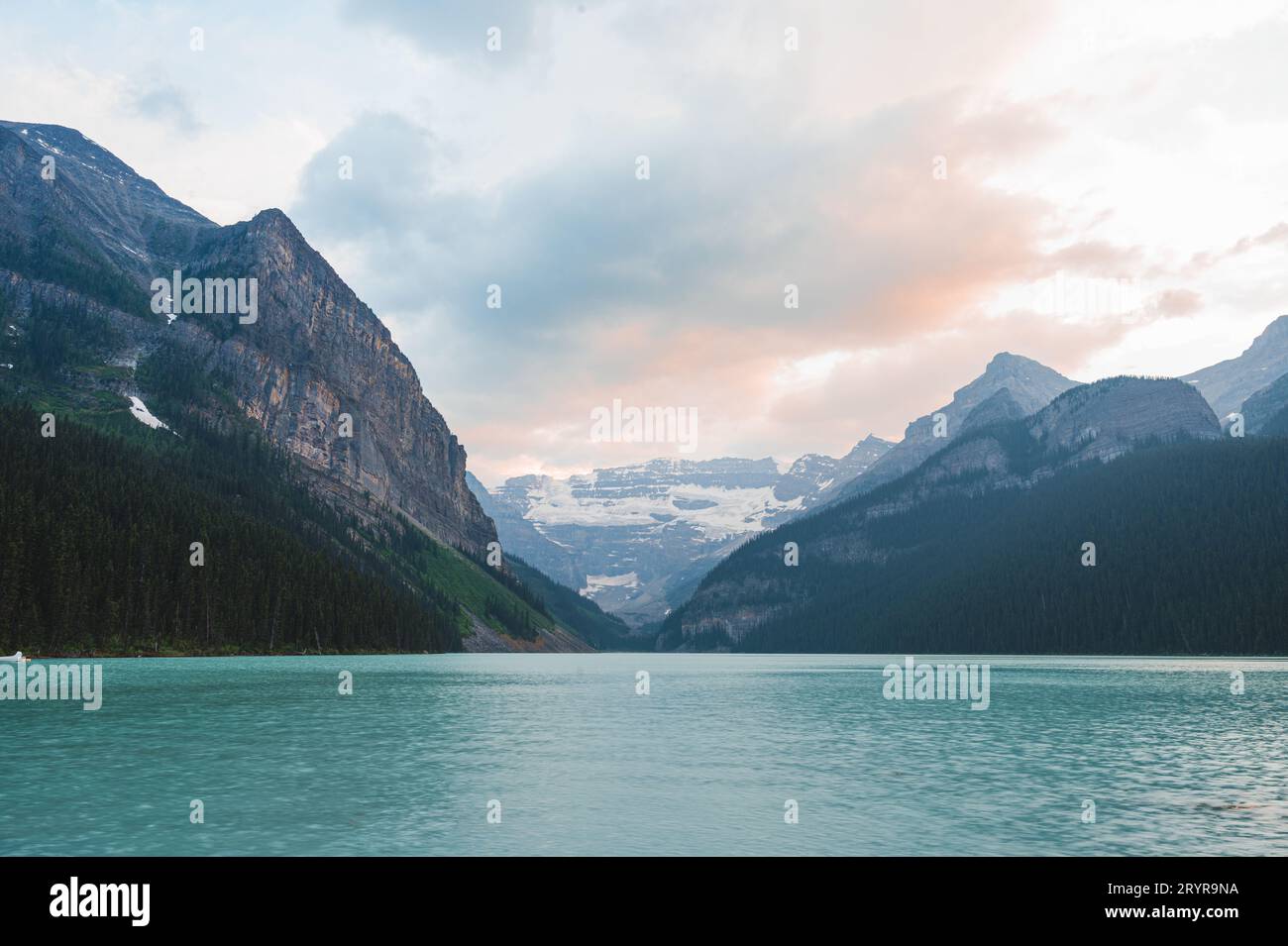 The scenic Lake Louise in Banff, Canada during golden hour Stock Photo ...