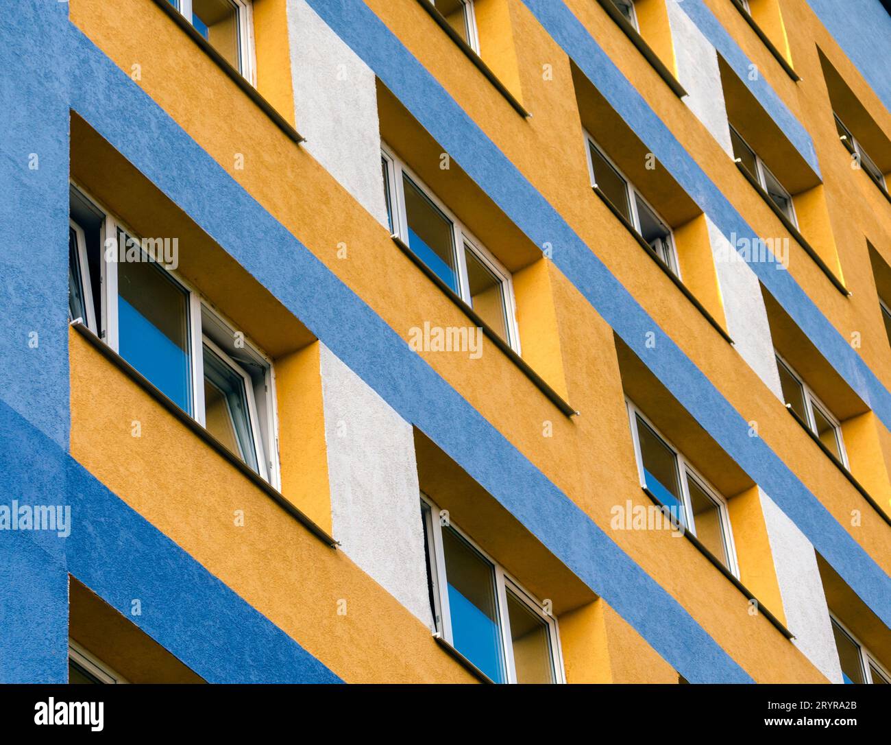 Modern house with yellow and blue walls and empty windows Stock Photo ...