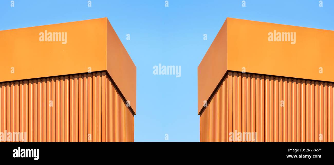 Orange wall of a modern building against a blue sky Stock Photo - Alamy