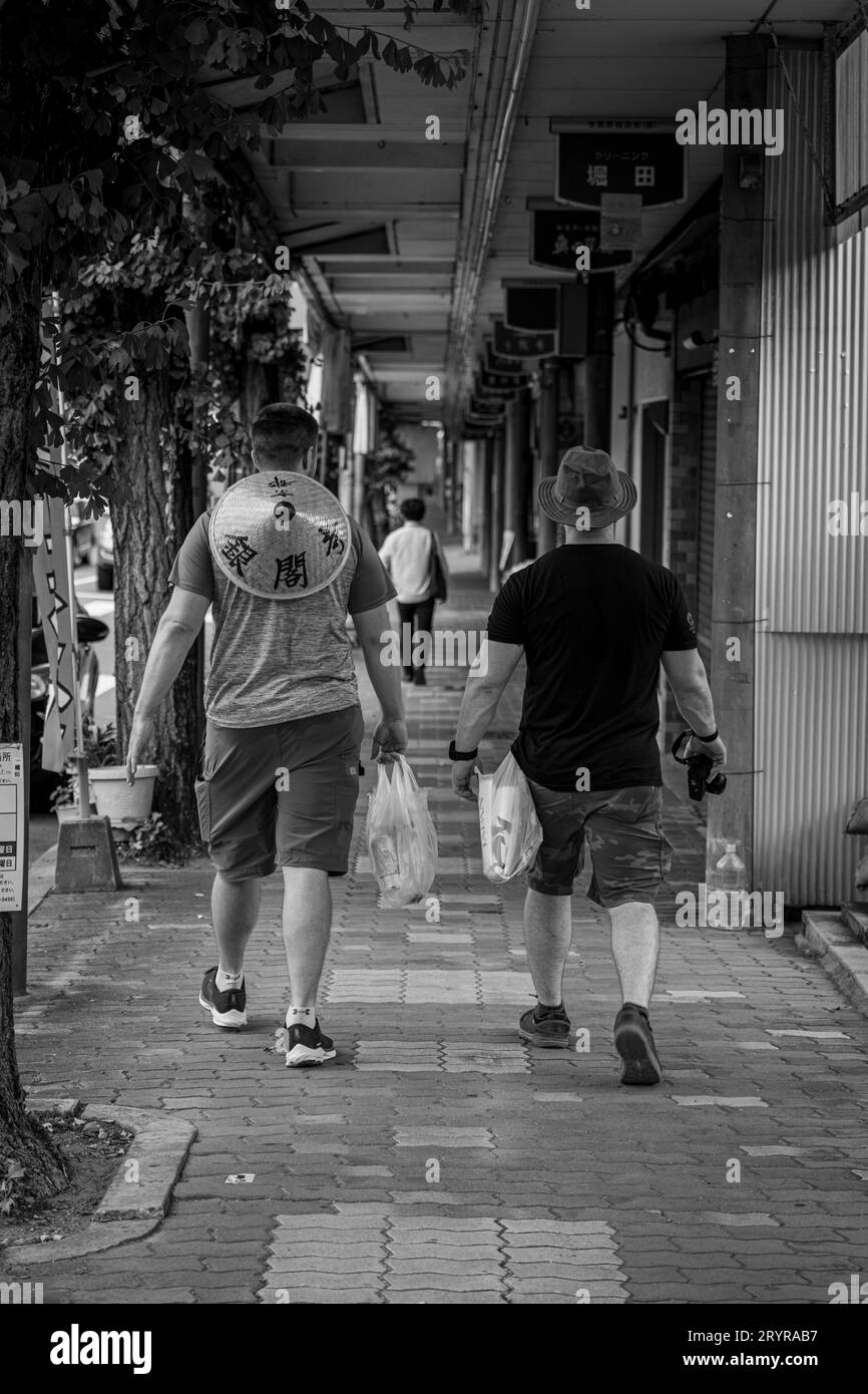 Walking with two individuals Black and White Stock Photos & Images - Alamy