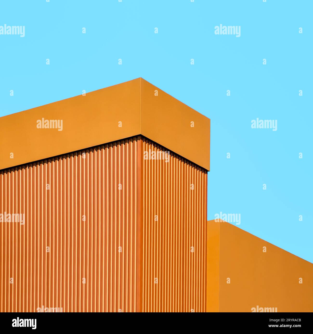 Orange wall of a modern building against a blue sky Stock Photo - Alamy