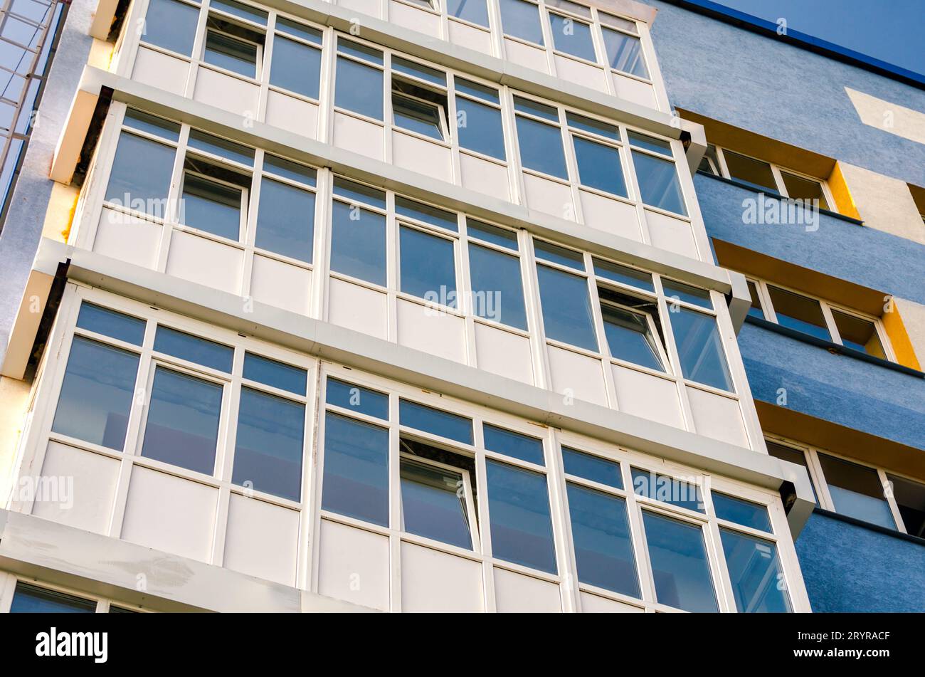 Modern house with yellow and blue walls and empty windows Stock Photo ...