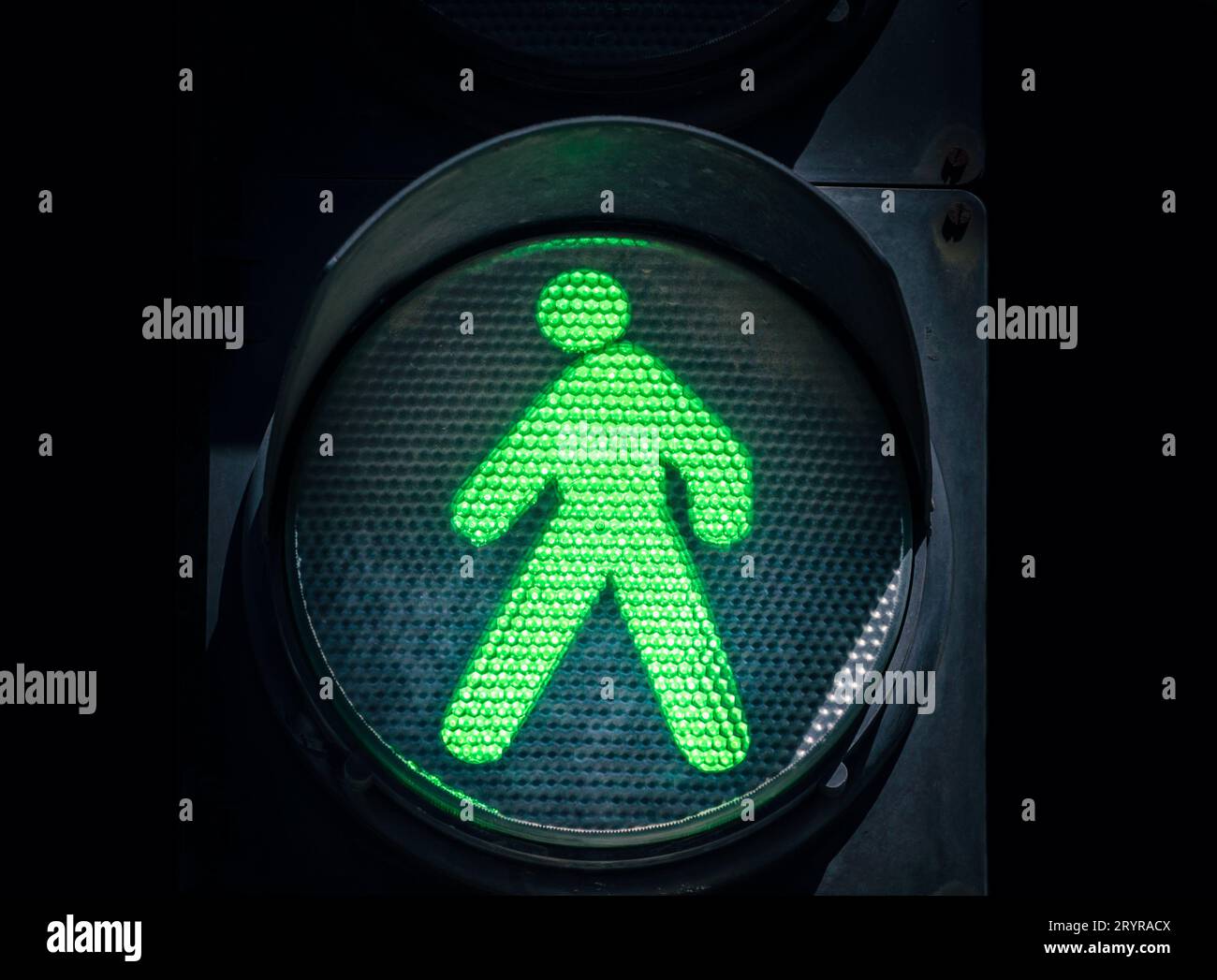 Traffic light with a green man on a black background Stock Photo - Alamy