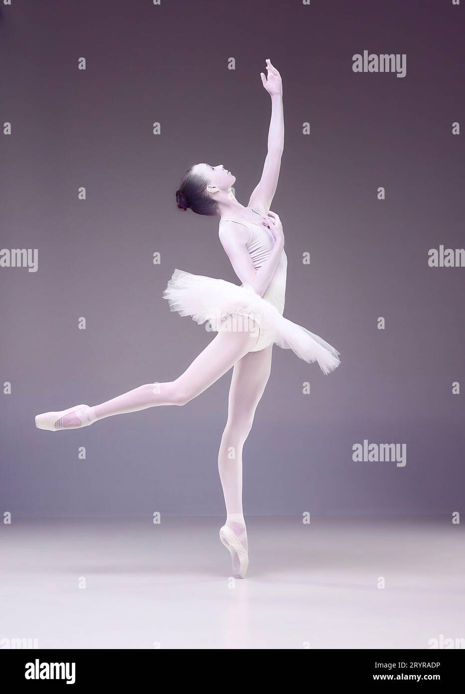 Full-length of tender young woman, professional ballerina posing over ...