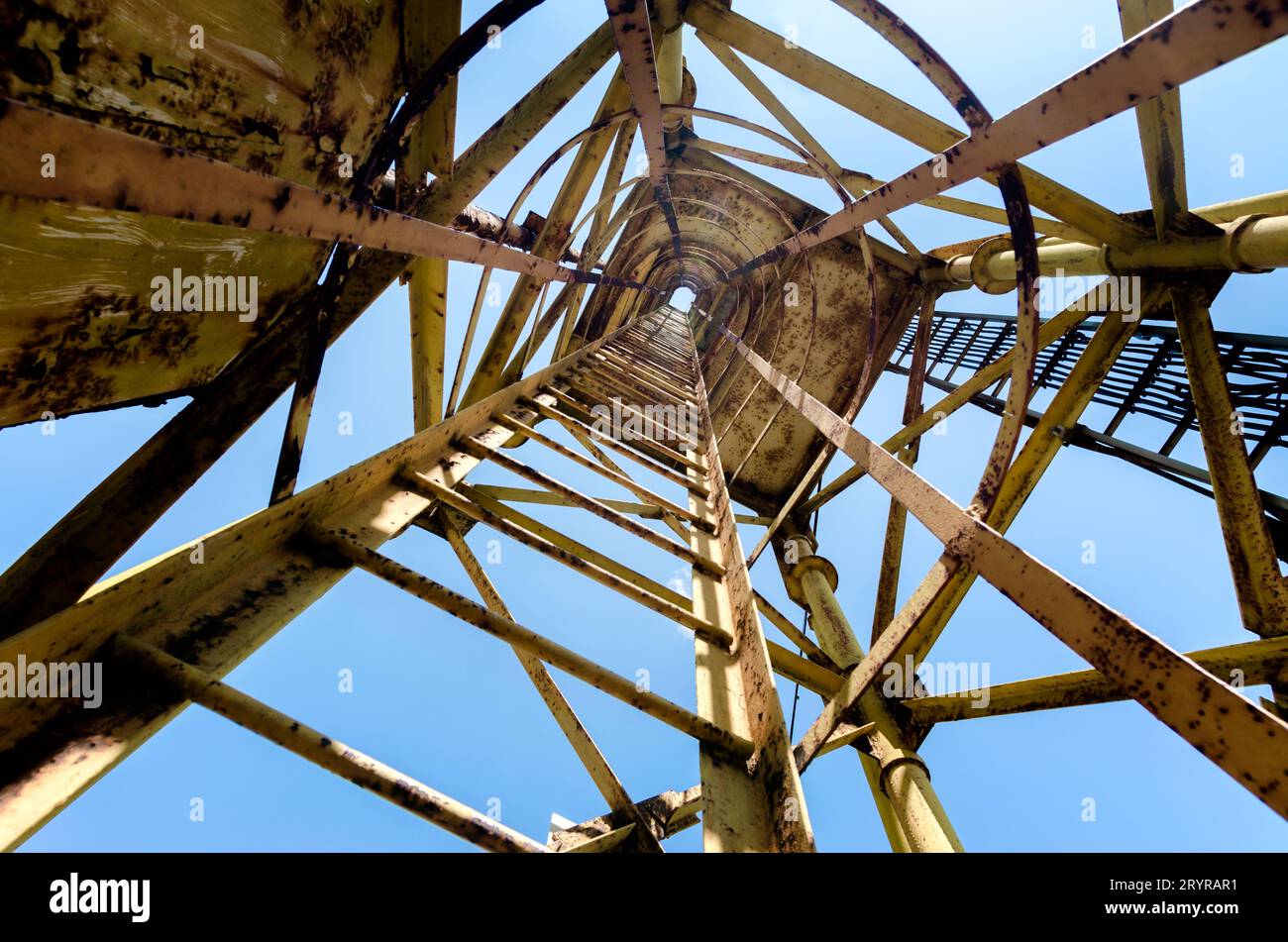 Old high metal tower building with stairs bottom view Stock Photo - Alamy