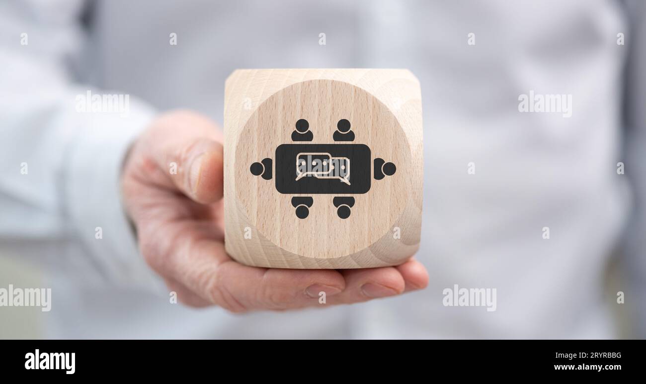 Hand holding a wooden cube with symbol of meeting concept Stock Photo ...
