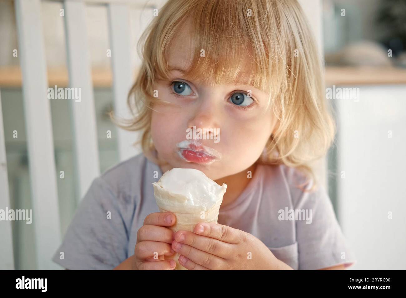 Baby girl enjoying ice cream. Pretty little toddler eating an ice-cream ...
