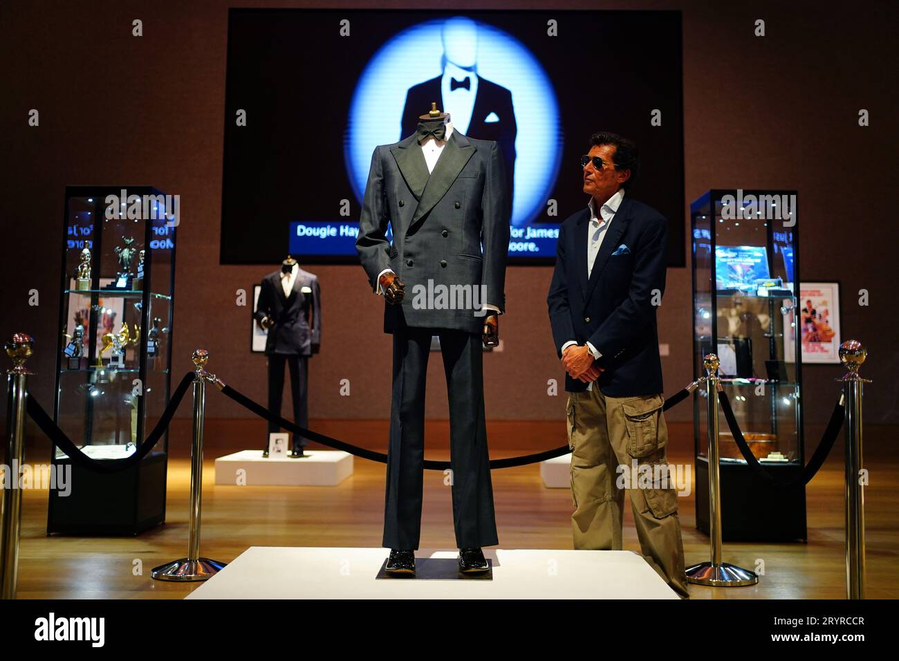 Sir Roger Moore's son, Geoffrey Moore, looks at a double-breasted ...