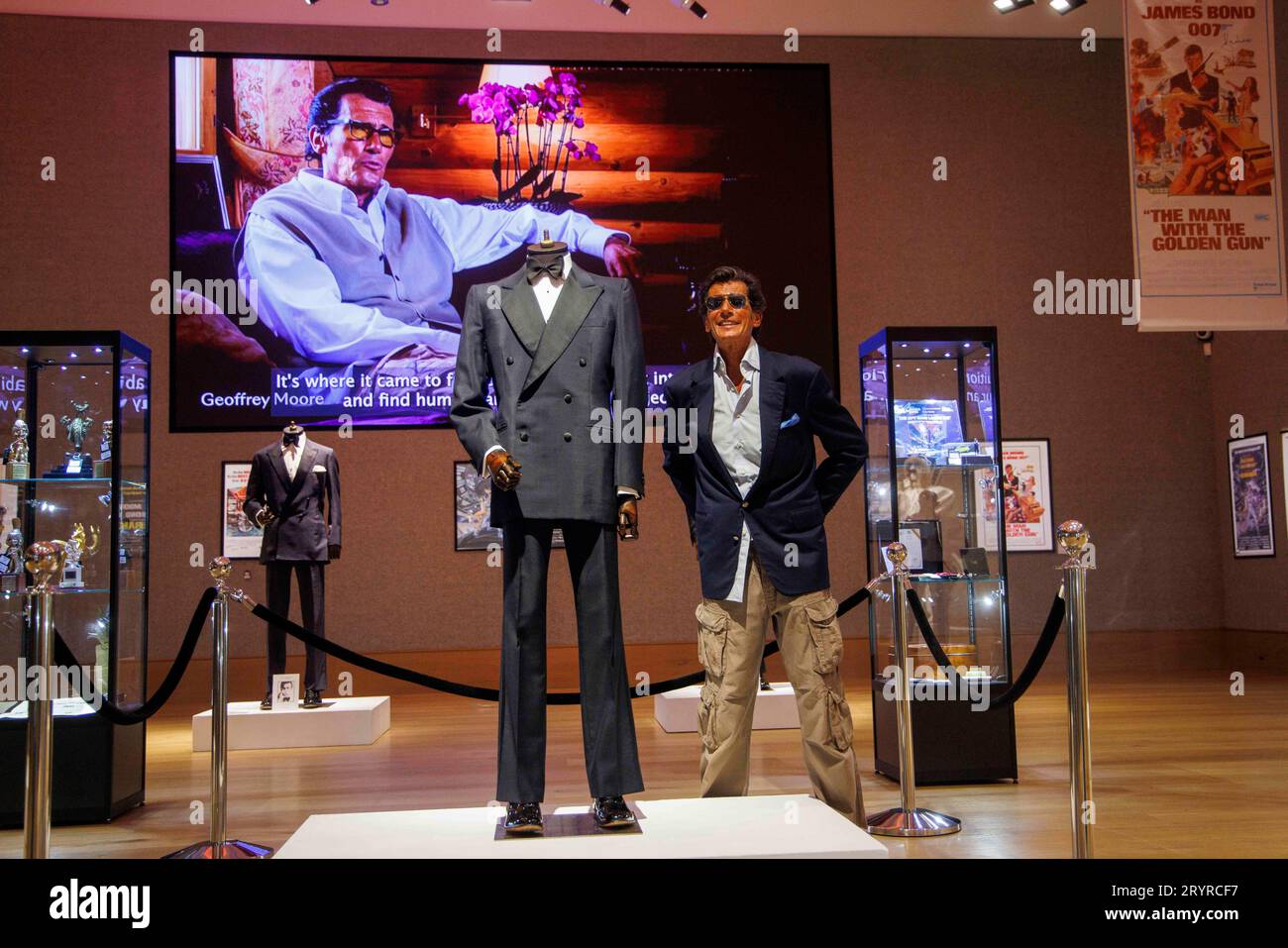 London, UK 2 Oct 2023 Roger MooreÕs son, Geoffrey, stands by a Double ...
