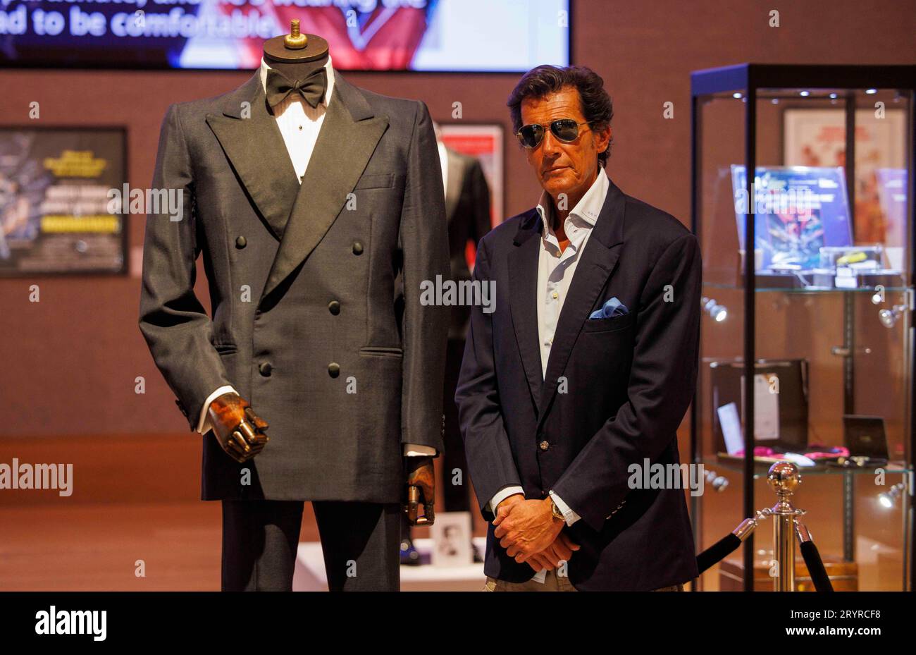 London, UK 2 Oct 2023 Roger MooreÕs son, Geoffrey, stands by a Double ...