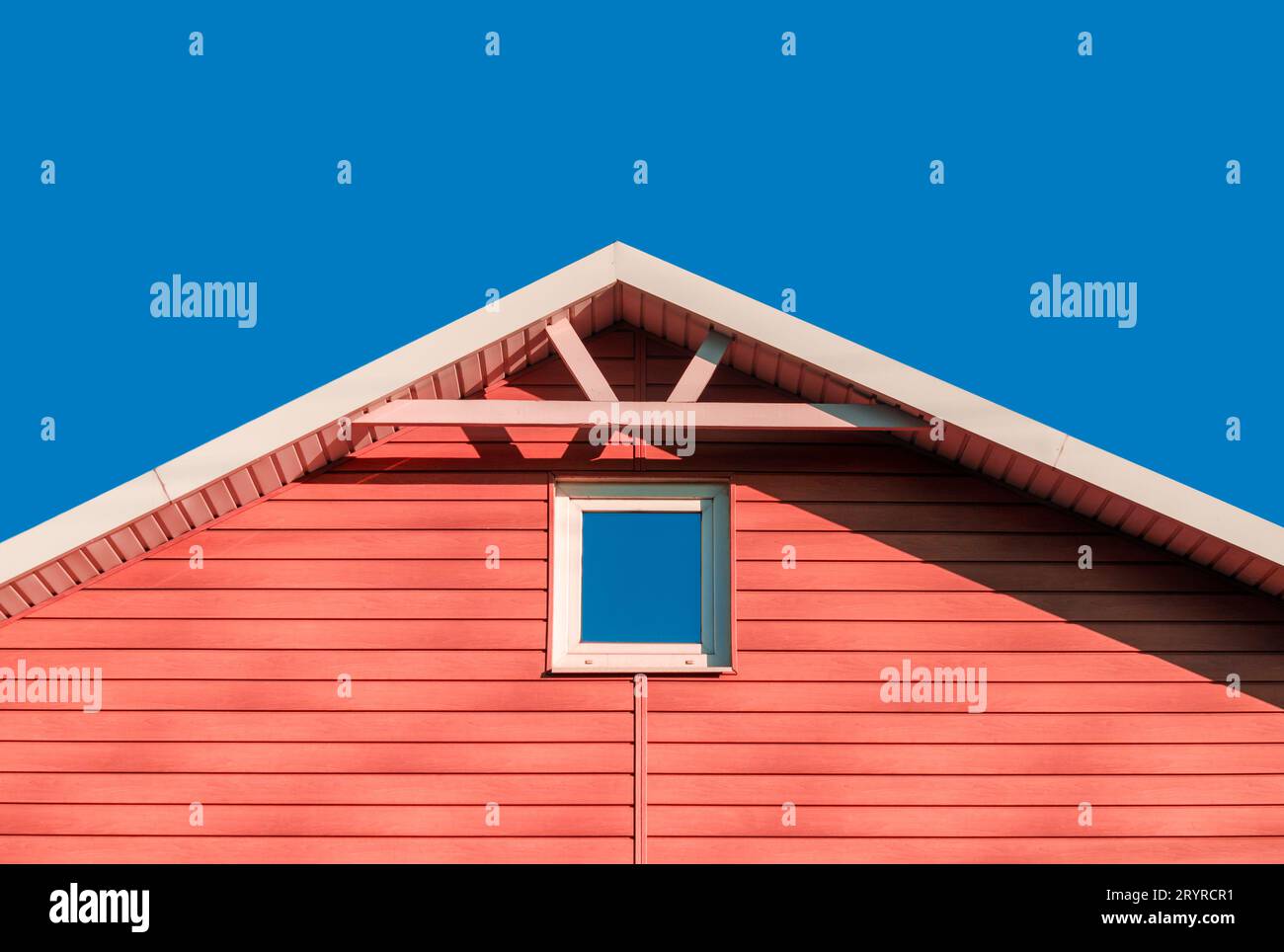 Roof of a pink farmhouse wooden house against a blue sky Stock Photo ...