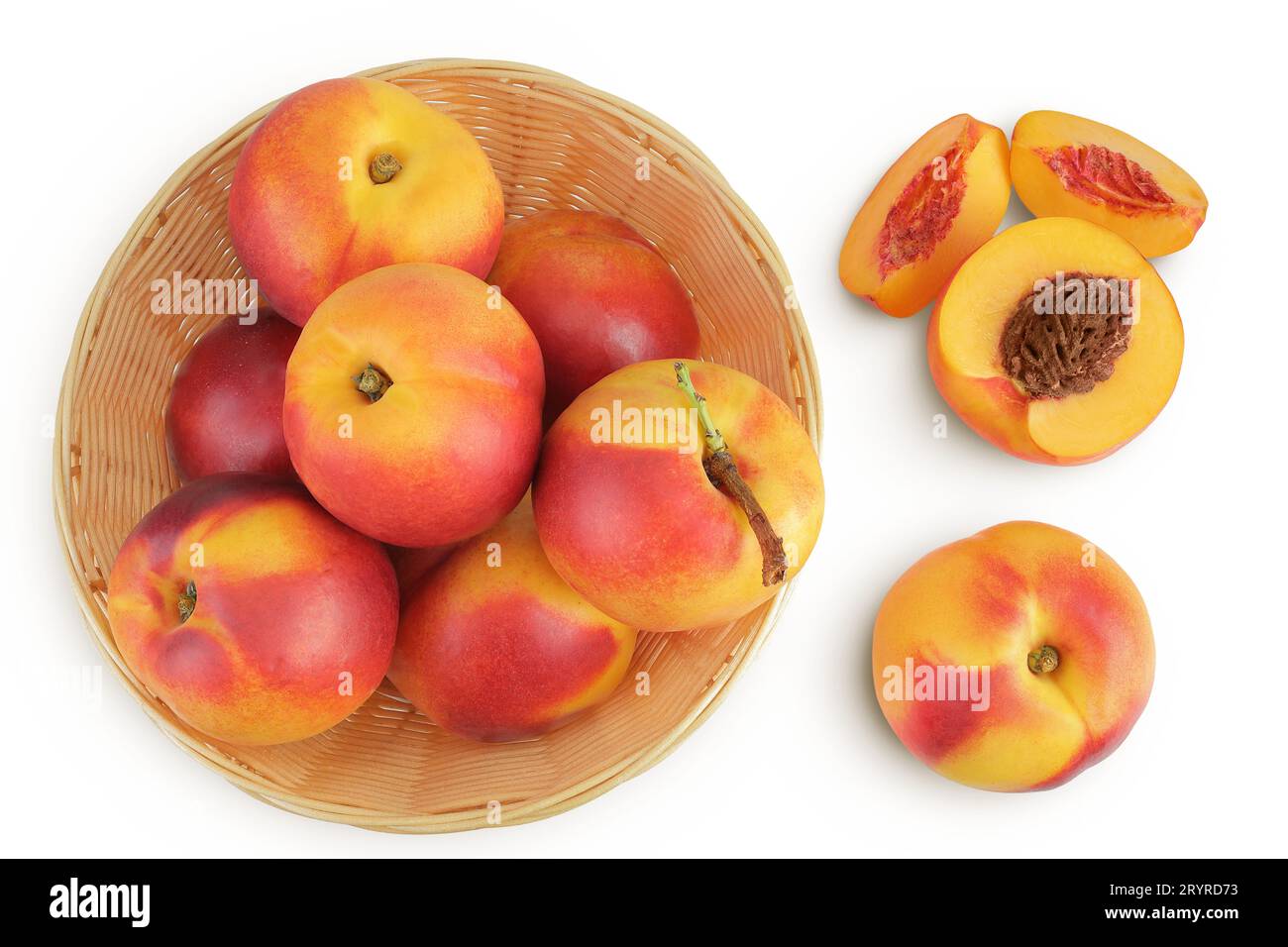Ripe nectarine fruit with half in a wicker basket isolated on white ...