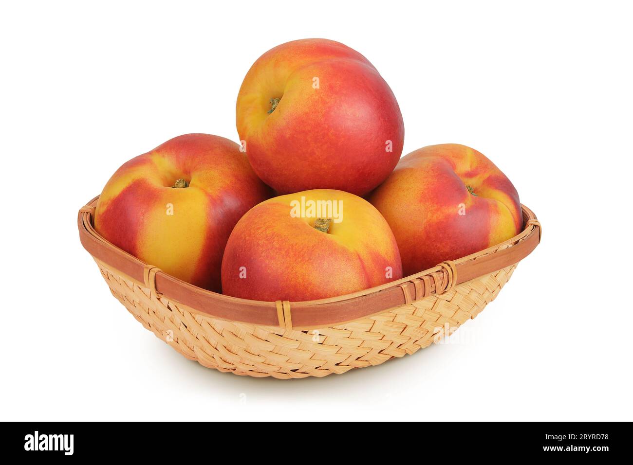 Ripe nectarine fruit in a wicker basket isolated on white background ...
