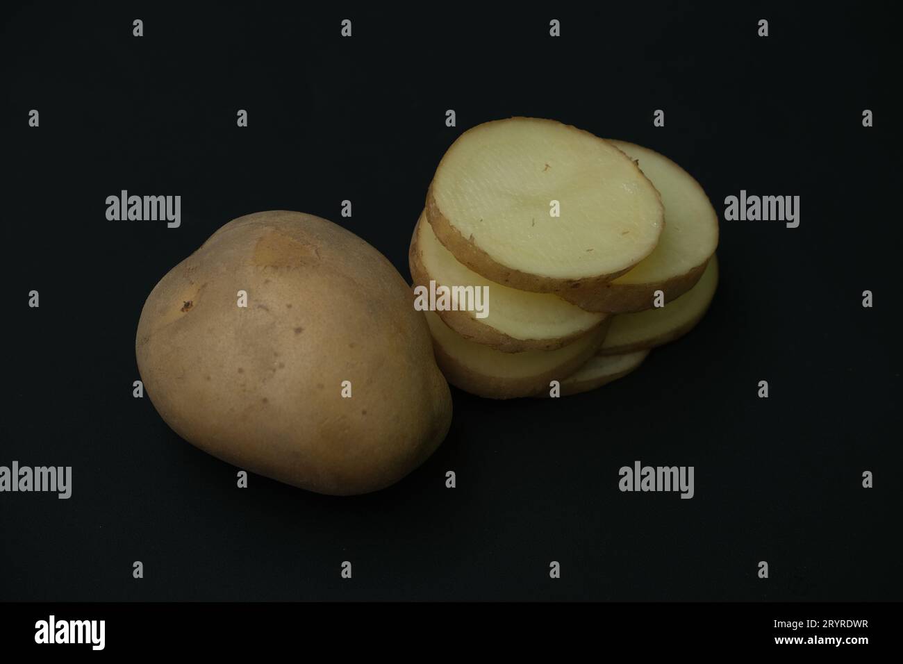 One and a half raw washed potato isolated on white background Stock ...