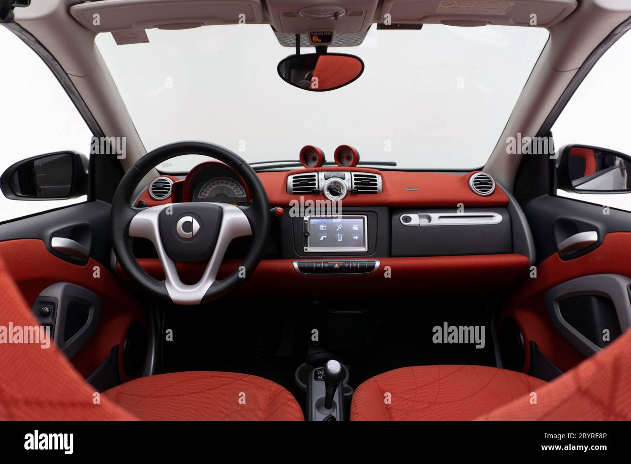 Red cloth smart fortwo dashboard, steering wheel and infotainment ...