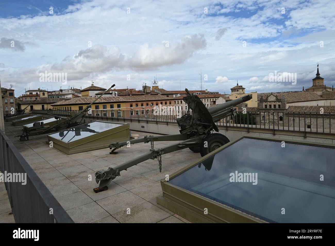 The historical cannon guns sitting on the rooftop of a large building ...