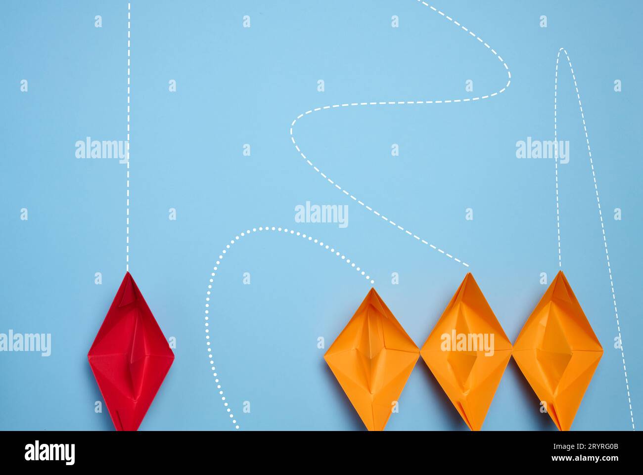 Paper boats on a blue background, representing the concept of ...
