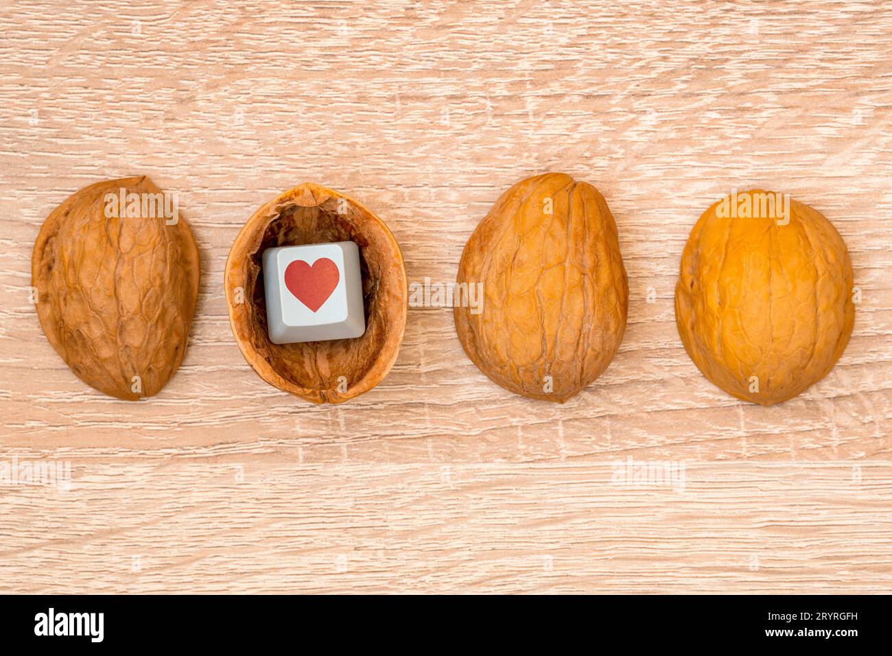 Nutshell with a keyboard key with a heart symbol Stock Photo - Alamy