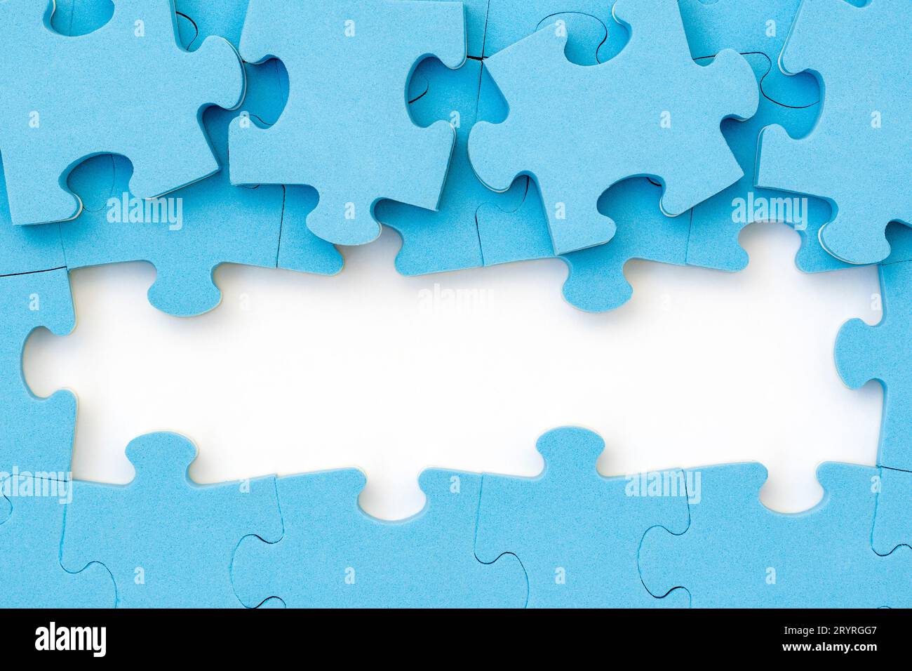 Four blue puzzle pieces revealing white background Stock Photo - Alamy