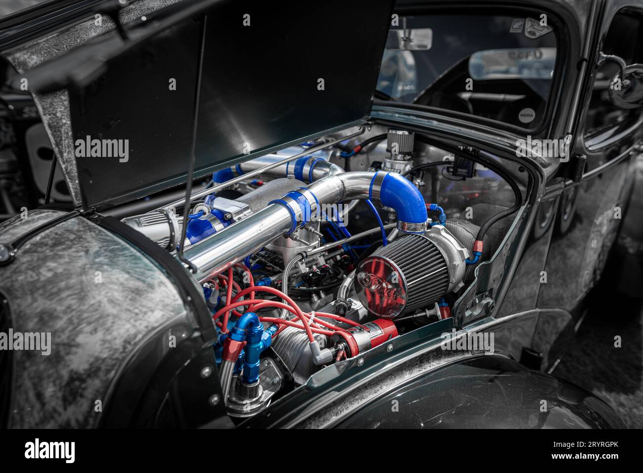 A close-up of a car with the hood open, revealing its engine Stock ...