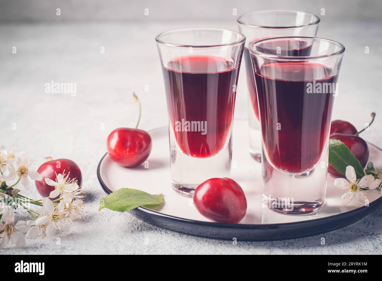 Cherry alcohol drink liquor or brandy on pink background Stock Photo ...