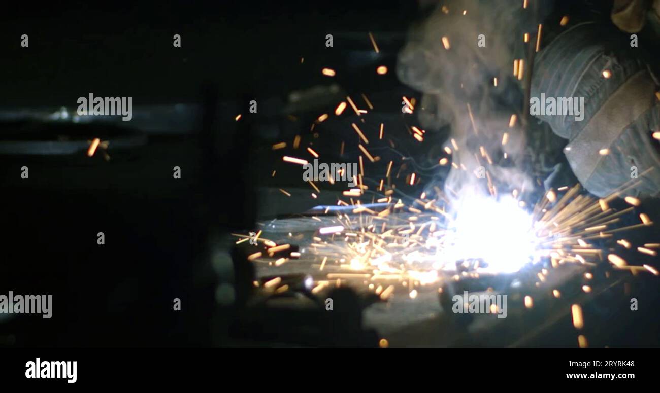 Welding robots movement in a car factory. Industrial welding robots ...