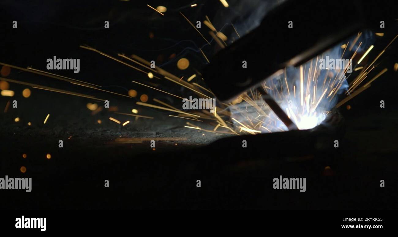 Welding robots movement in a car factory. Industrial welding robots ...