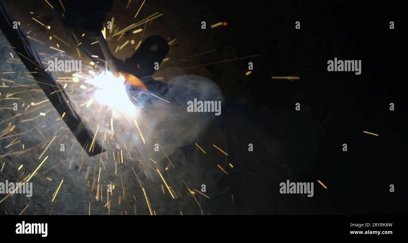 Welding robots movement in a car factory. Industrial welding robots ...