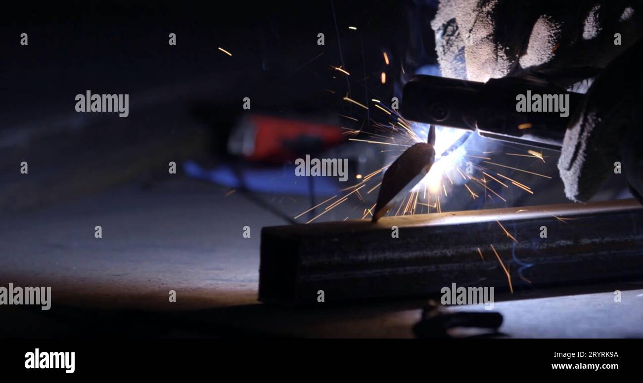 Welding robots movement in a car factory. Industrial welding robots ...