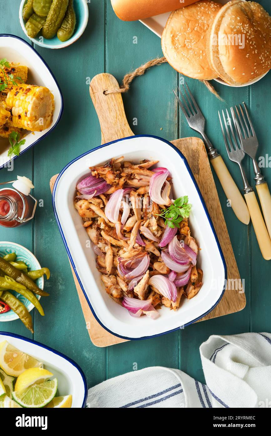 Pulled bbq chicken with baked onions on serving platter, bbq corn ...