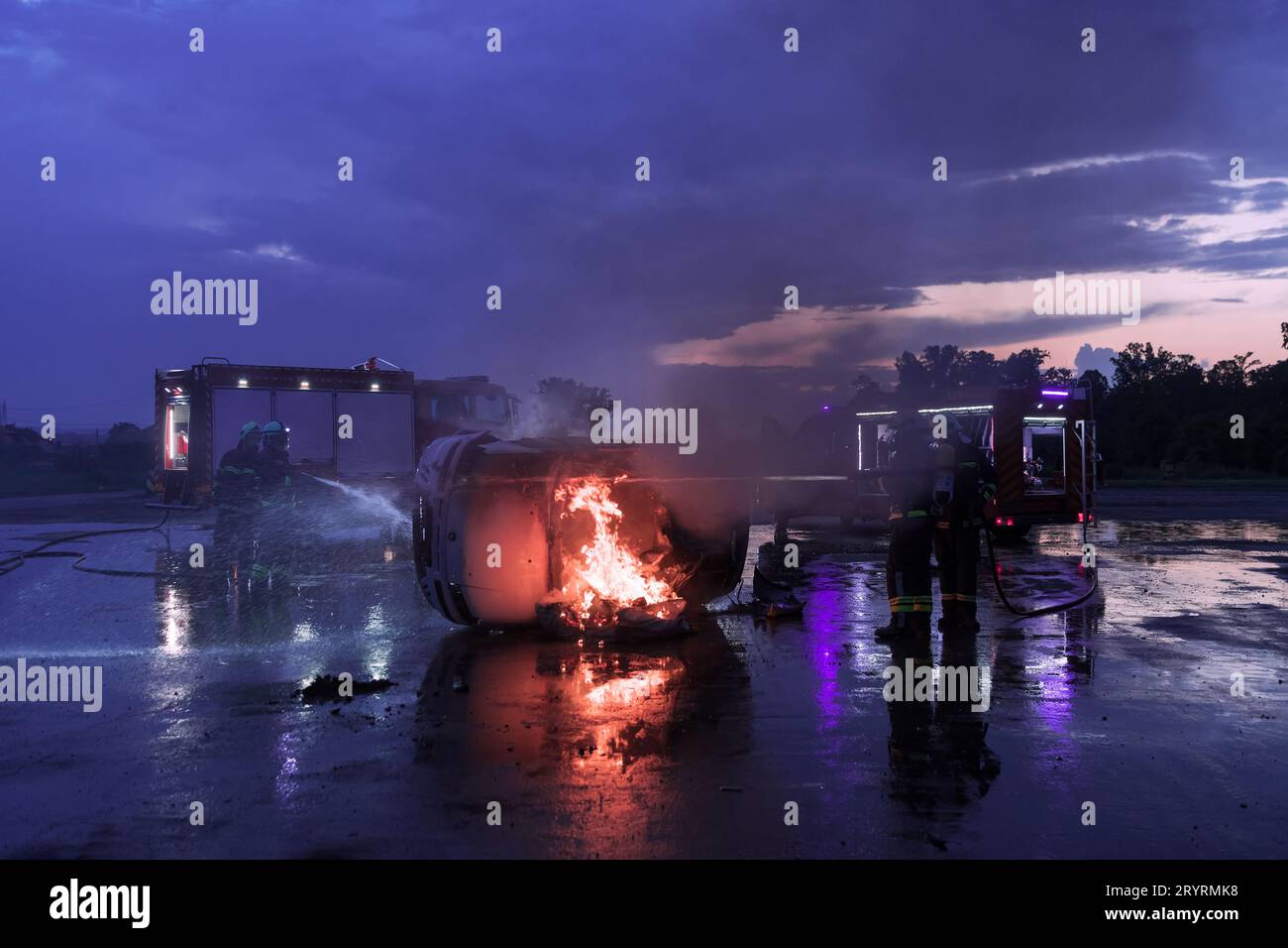 Firefighters using water fire extinguisher to fighting with the fire ...