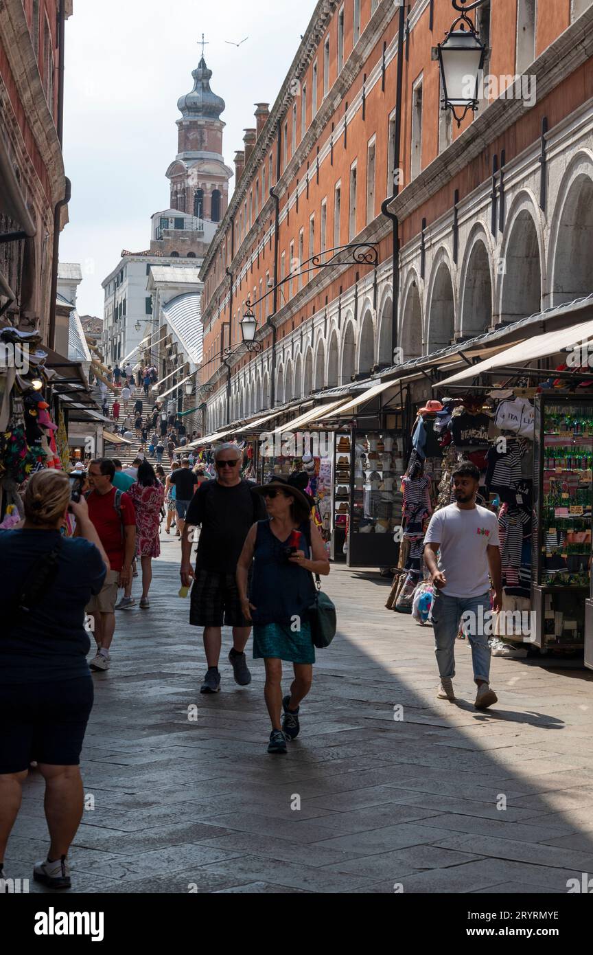 Tourists stroll along Ruga dei Oresi with small shops and stalls on ...