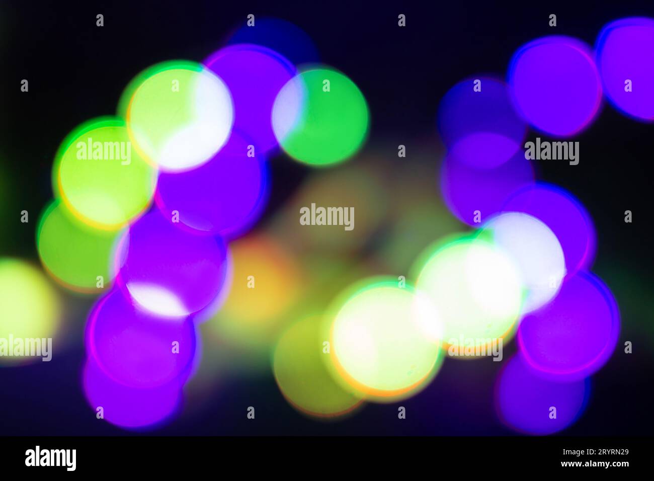 Duotone green and purple blurry neon lights on black Stock Photo - Alamy