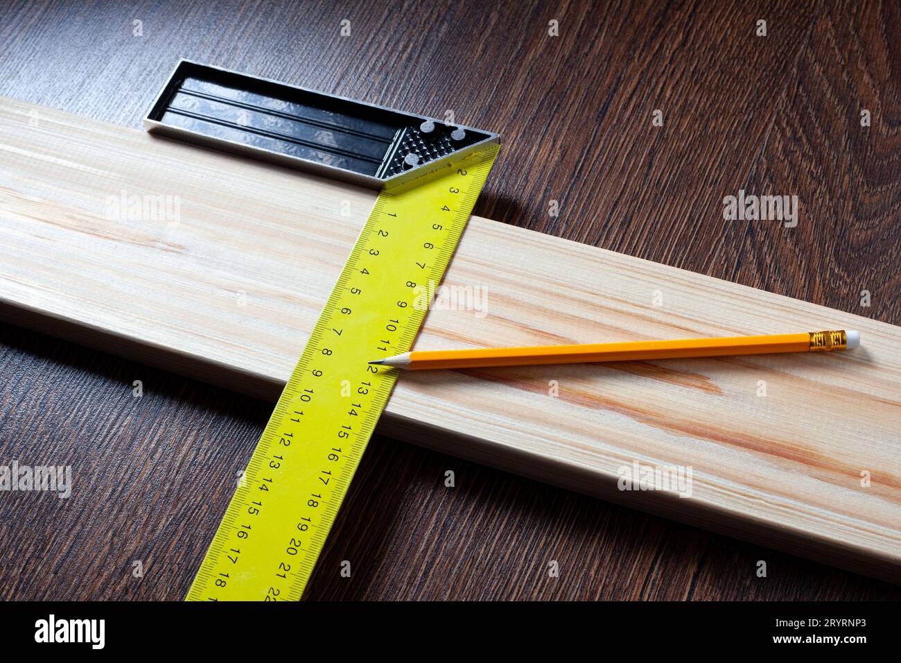 Square ruler and pencil for measuring on wooden board. construction ...